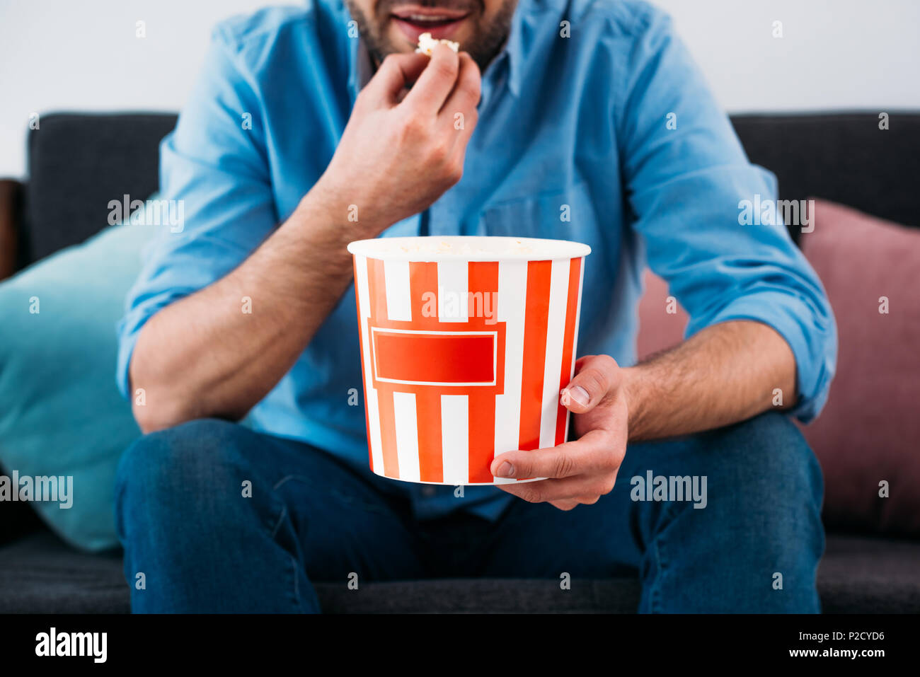 partial view of man eating popcorn Stock Photo - Alamy