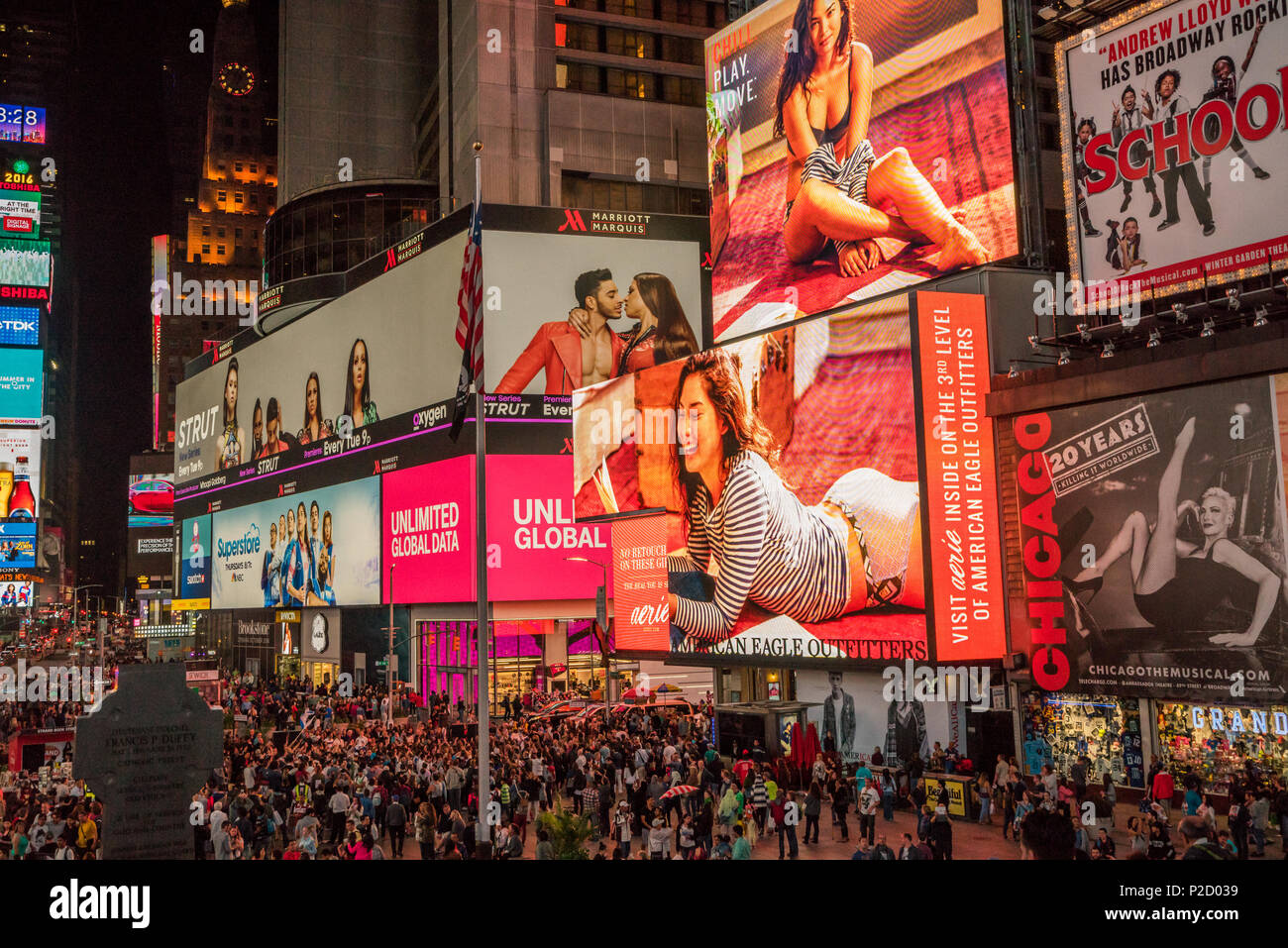 Crowds gather to see the spectacle of Times Square at night with the ...