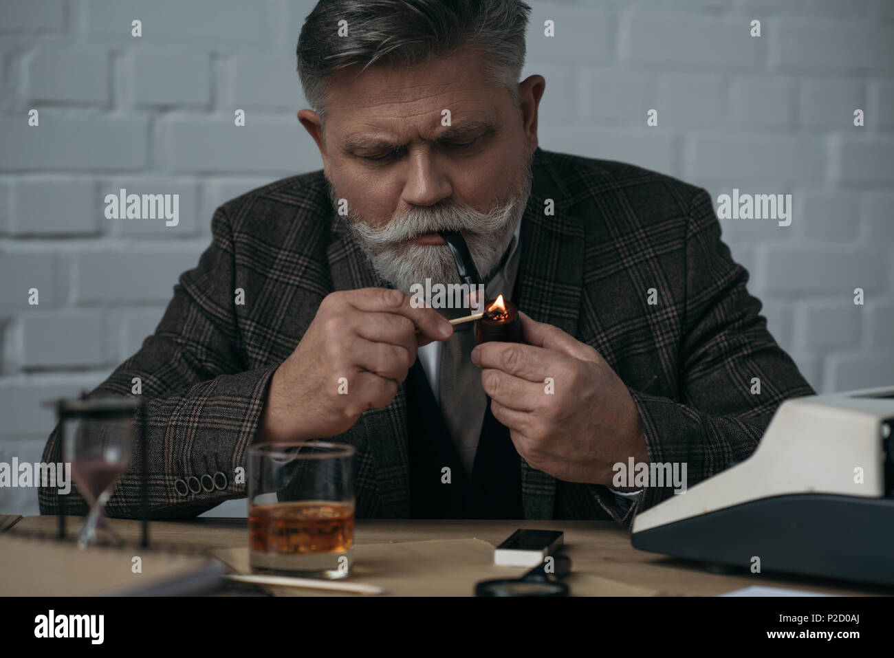 serious senior writer smoking pipe at workplace Stock Photo - Alamy