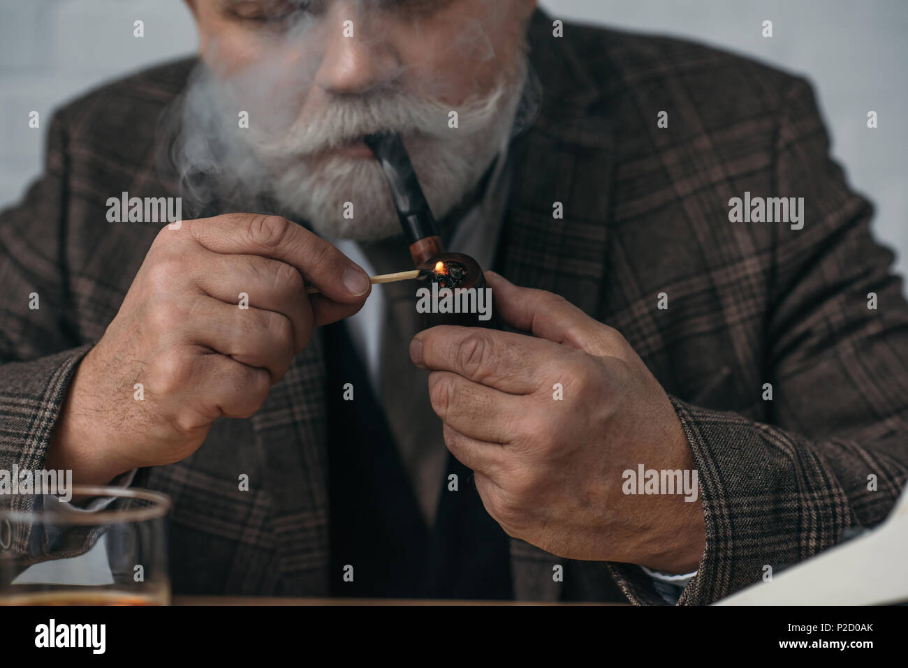 Old man smoking pipe fire hi-res stock photography and images - Alamy