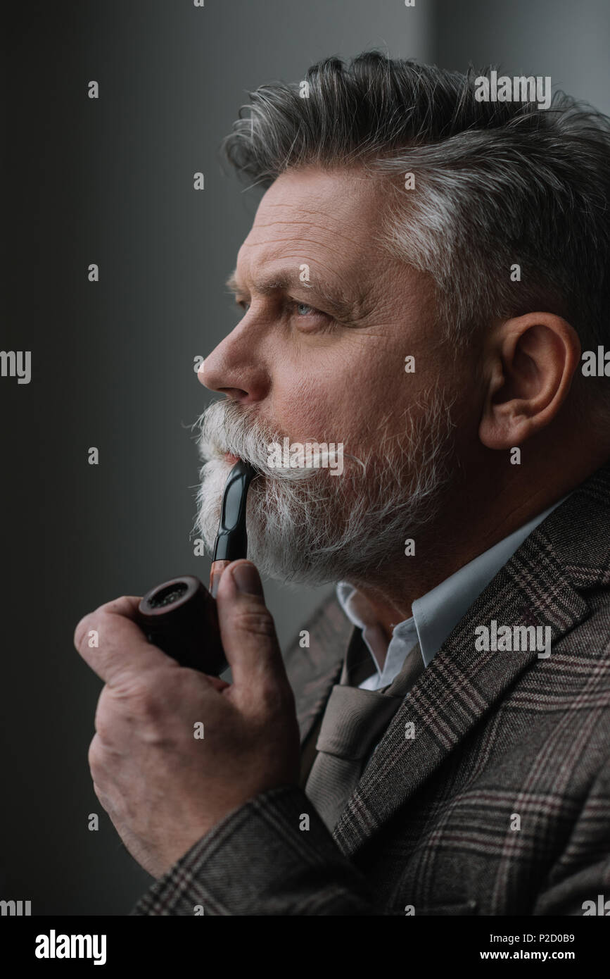 handsome senior man in tweed costume smoking pipe Stock Photo - Alamy