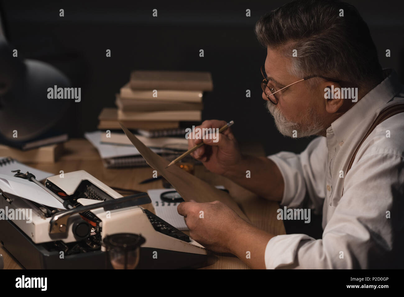 serious senior writer working with manuscript Stock Photo - Alamy