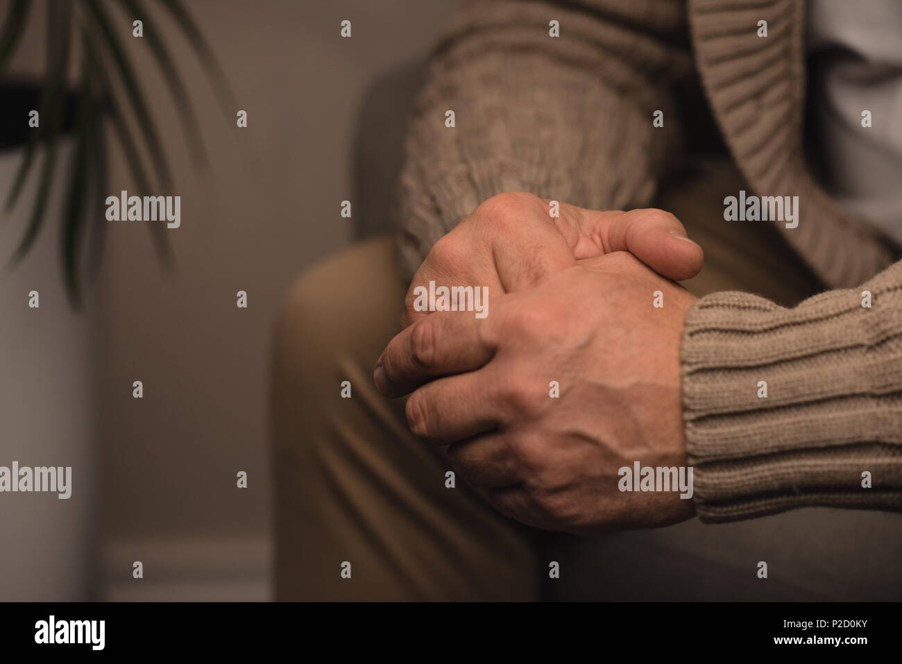 cropped shot of senior man holding his own hands Stock Photo - Alamy
