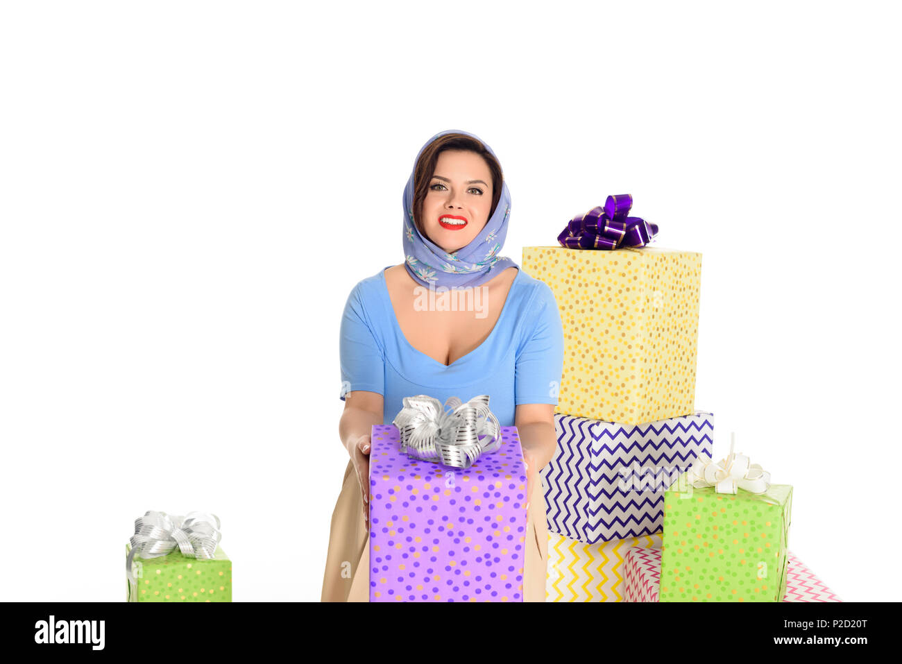 beautiful pin up woman holding gift box and smiling at camera isolated ...