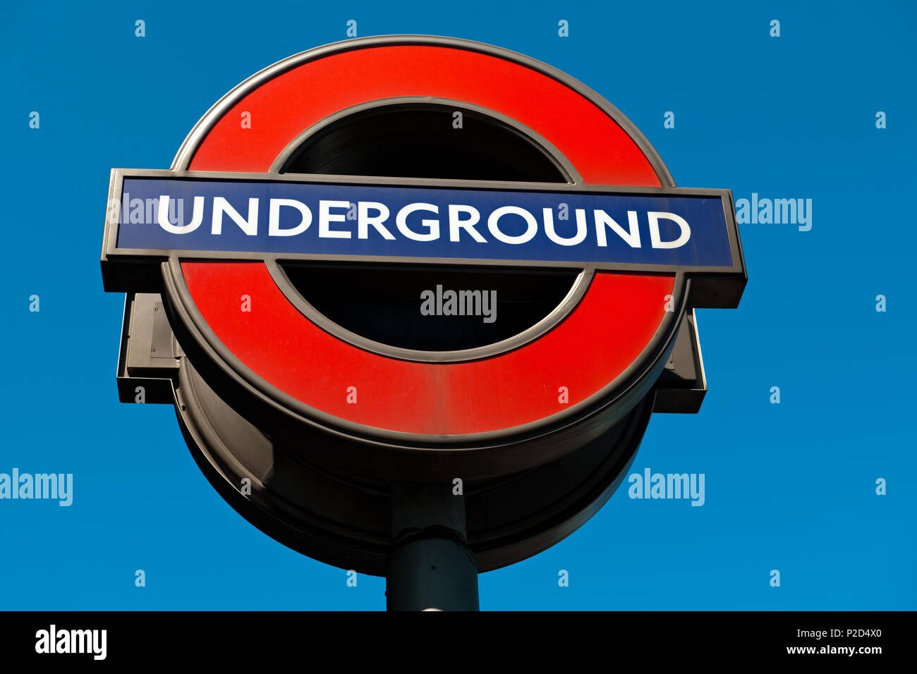 Underground sign against the blue sky, London Stock Photo - Alamy