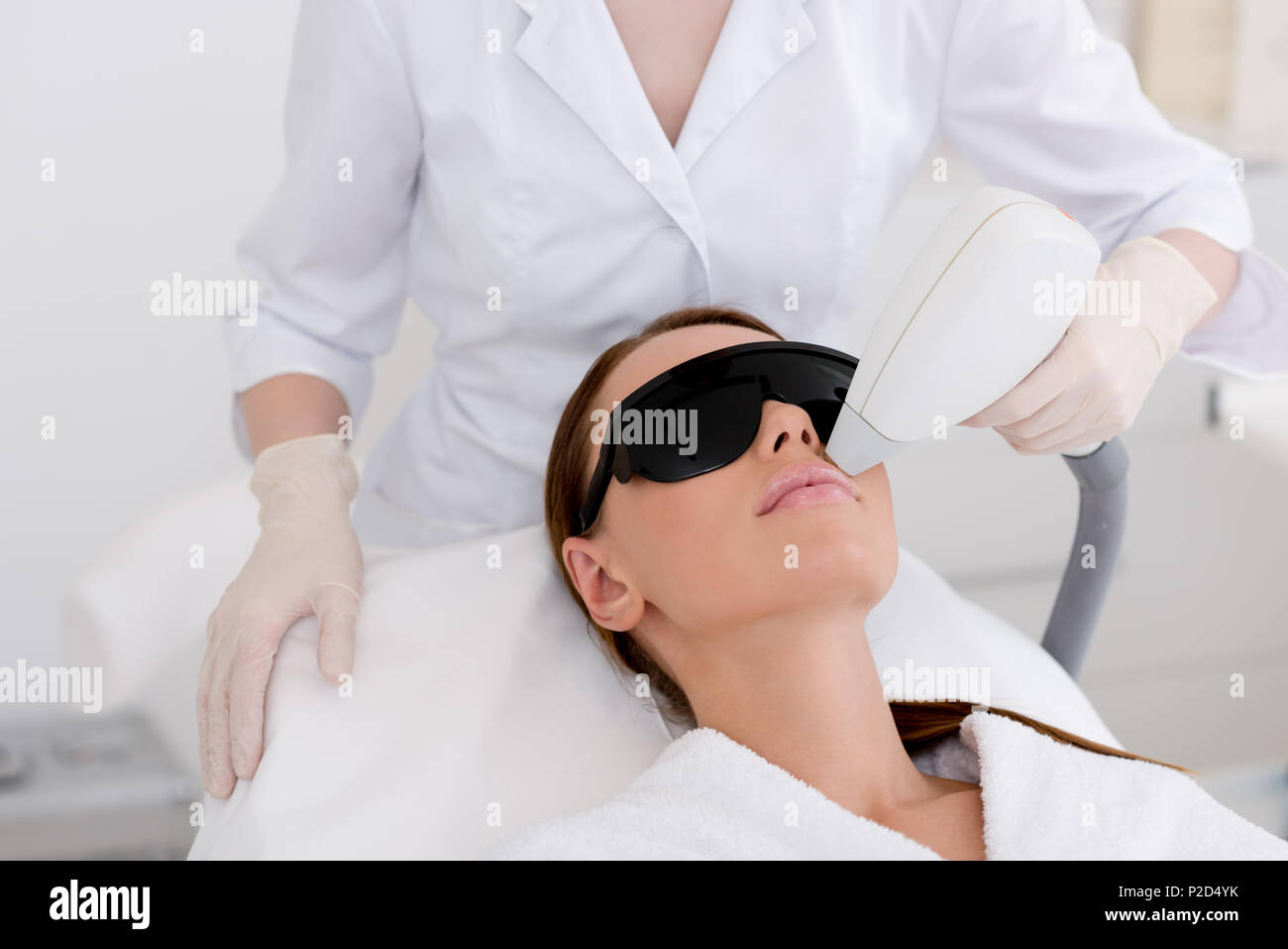 partial view of young woman receiving laser hair removal epilation on ...