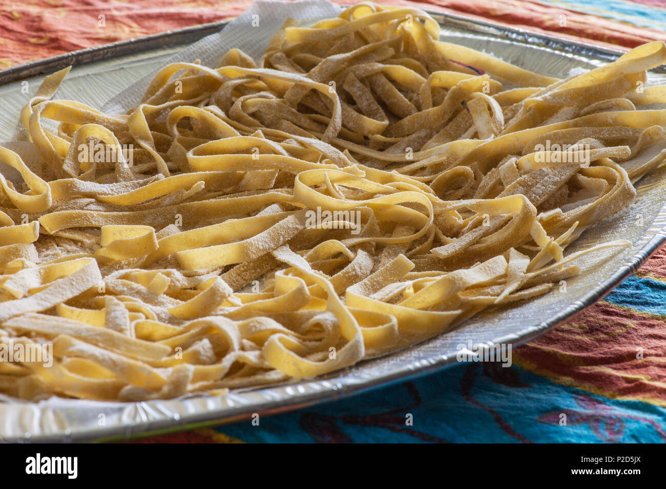 Tray with homemade pasta on a table with cloth Stock Photo - Alamy
