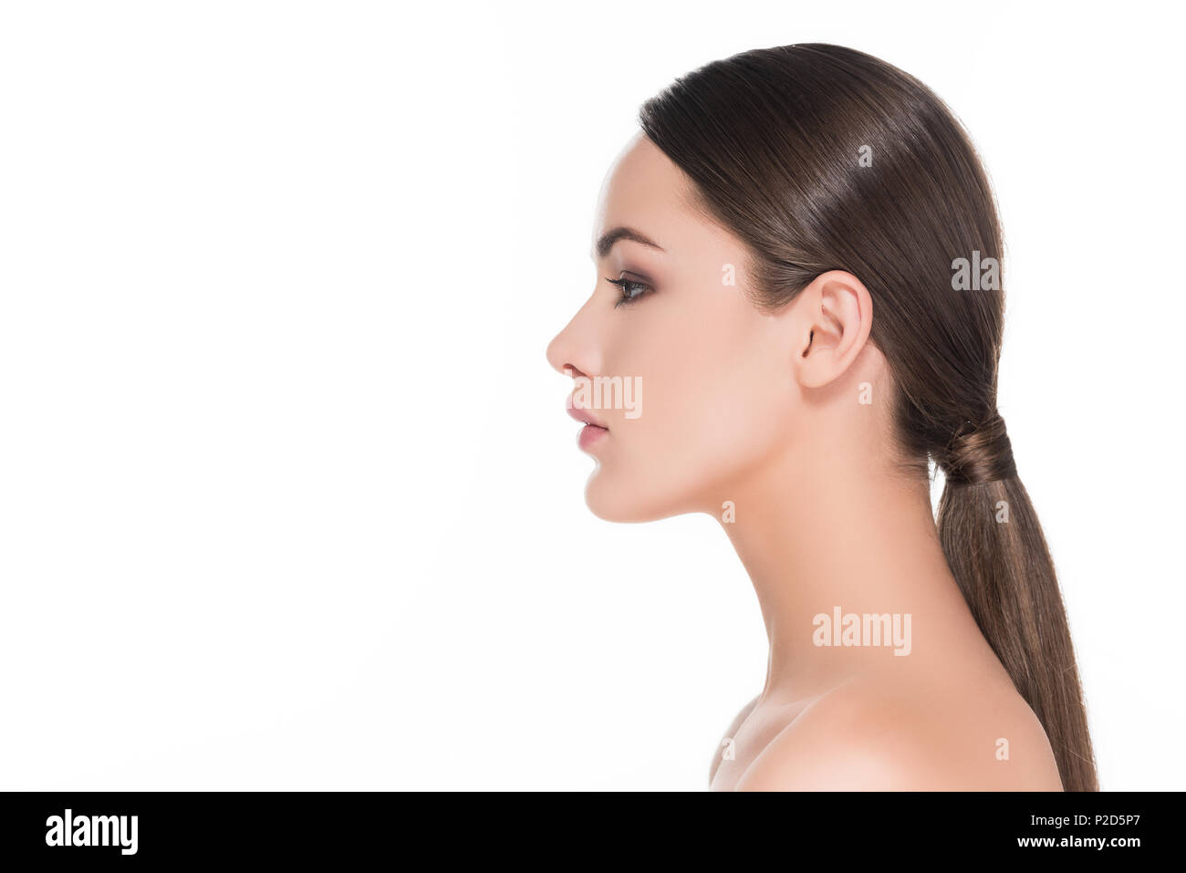 side view of beautiful young woman with pony tail isolated on white ...