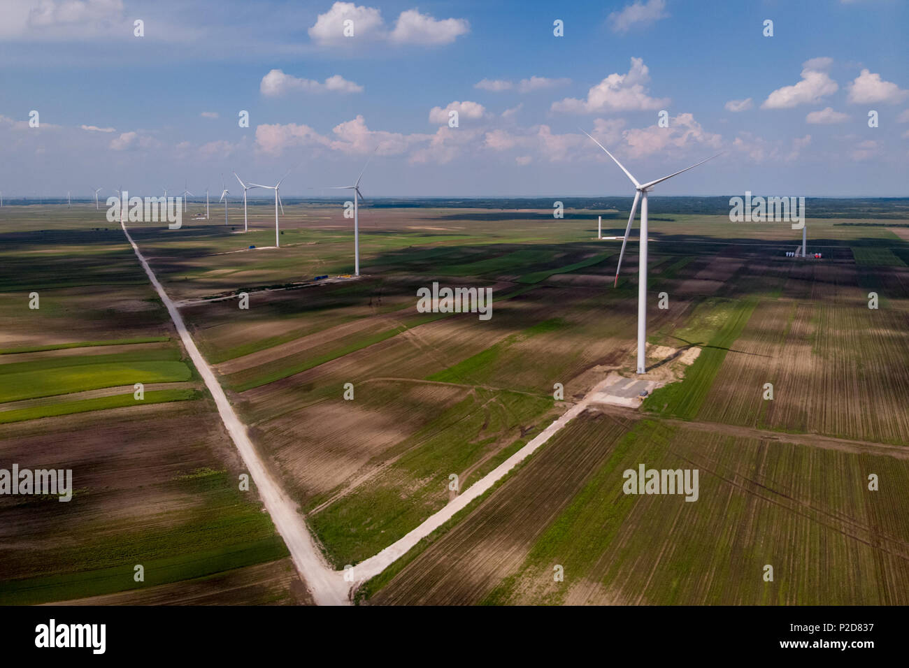 Wind farm, aerial view with bright blue cloudy sky. Sustainable development, renewable energy ...