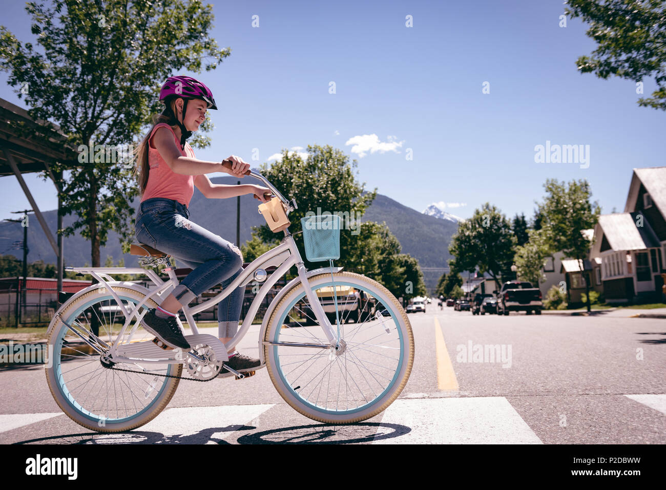 Girl riding bicycle on the zebra crossing Stock Photo - Alamy
