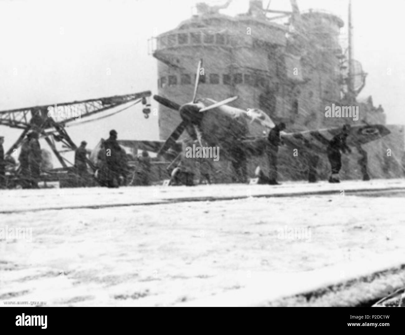 . Sailors working on a Sea Fury aircraft on the deck of HMAS Sydney ...