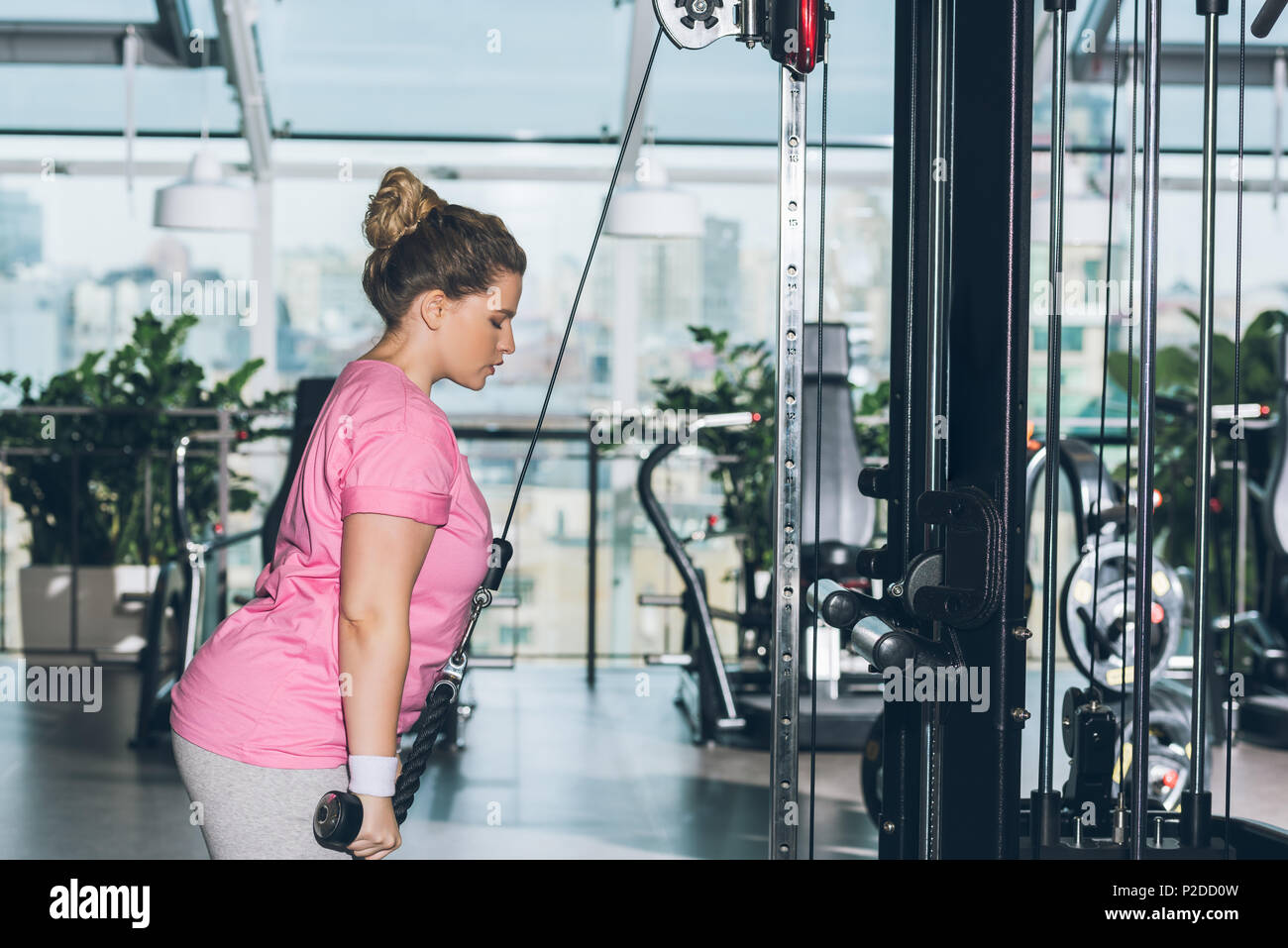 overweight woman working out on training apparatus Stock Photo - Alamy