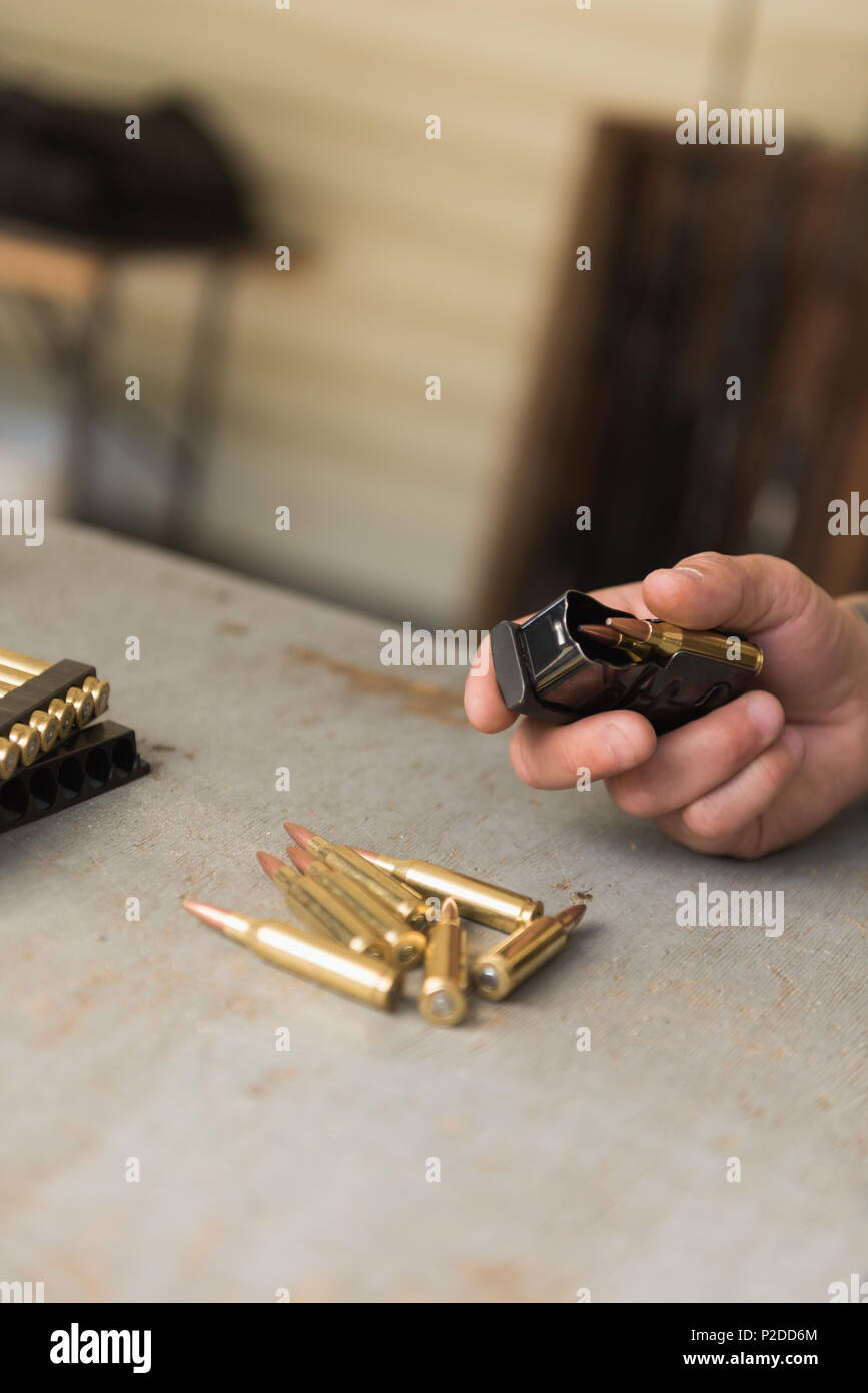 Man holding bullets in hand Stock Photo - Alamy