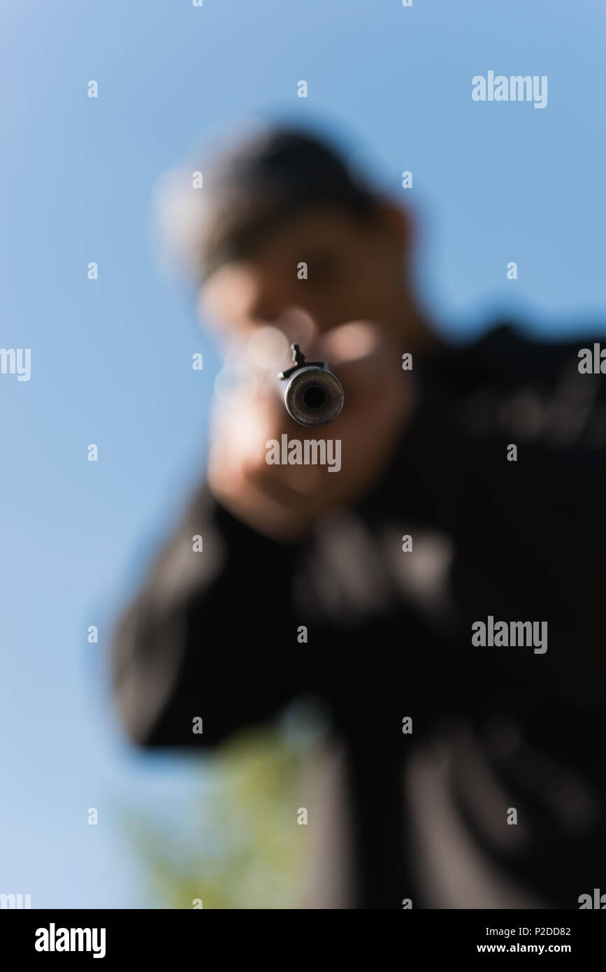 Man aiming sniper rifle at target in shooting range Stock Photo - Alamy