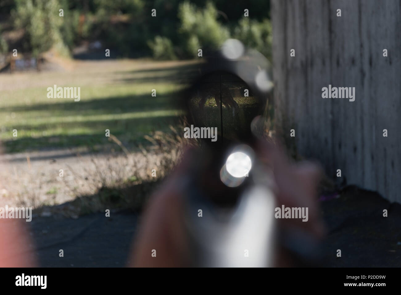 Blurry man aiming sniper rifle at target in shooting range Stock Photo ...