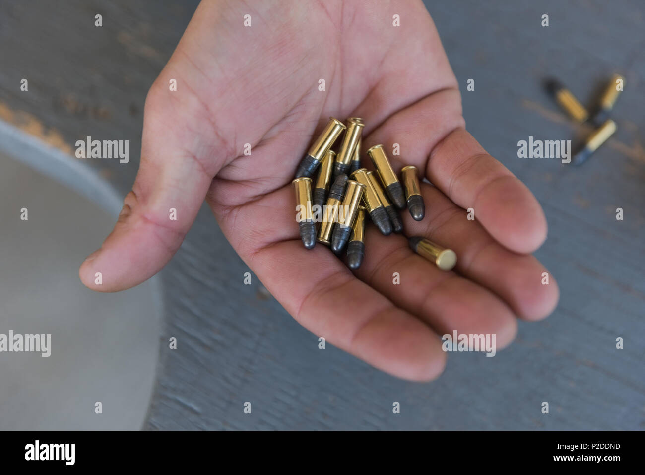 Man holding bullets in hand Stock Photo - Alamy