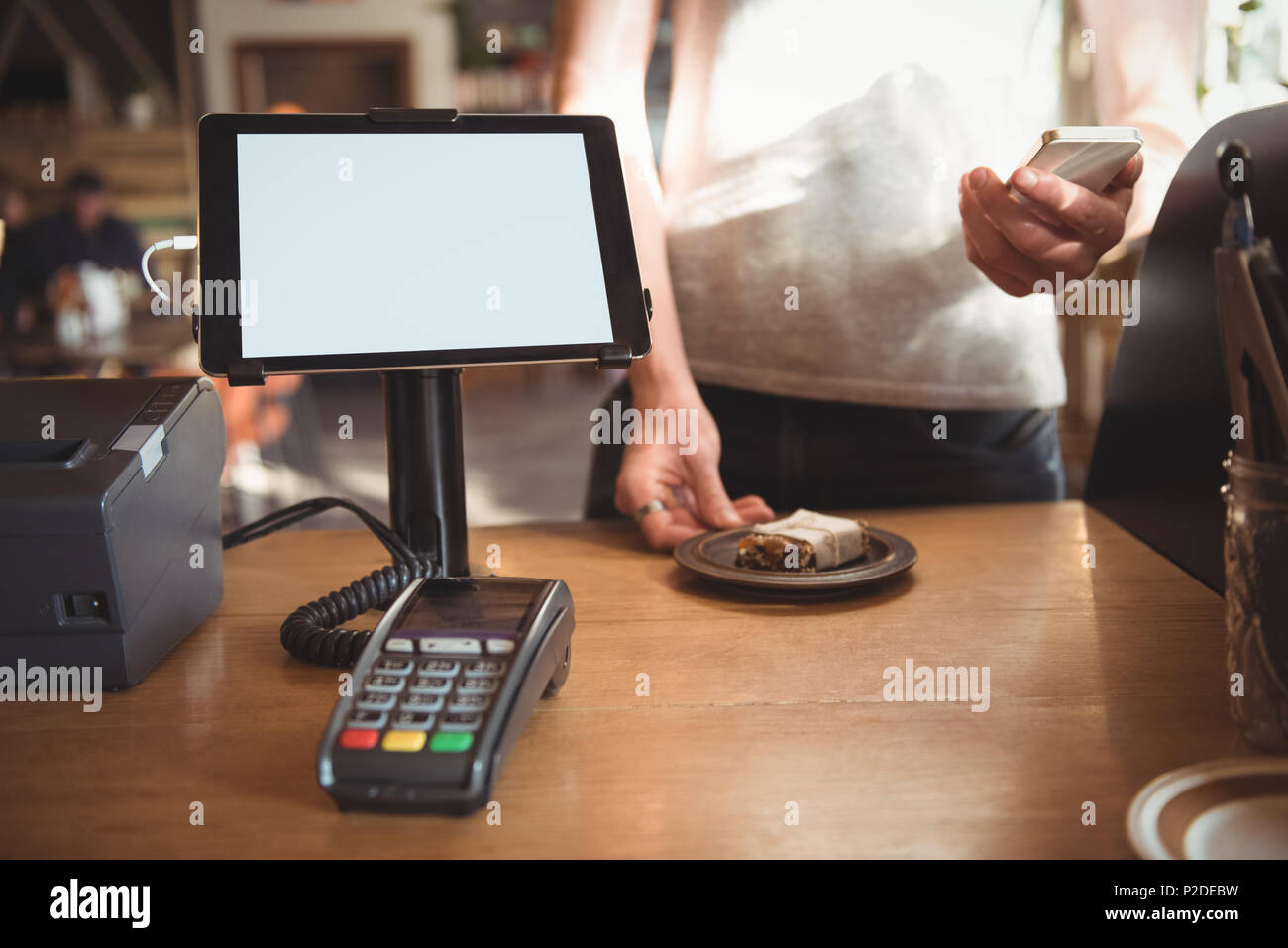 Mid section of waiter using mobile phone while serving breakfast Stock ...