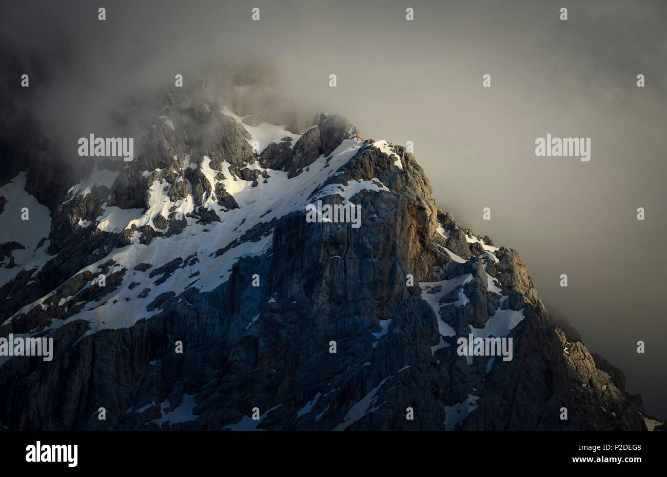 Prisojnik mountain range with clouds at sunset light, snow, Prisanc ...