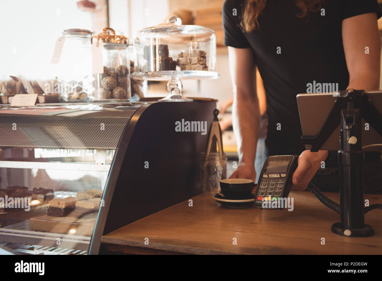 Mid section of waiter receiving payment at counter Stock Photo - Alamy