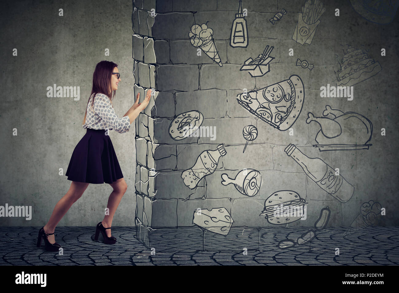 Side view of a motivated young woman resisting temptation of eating ...