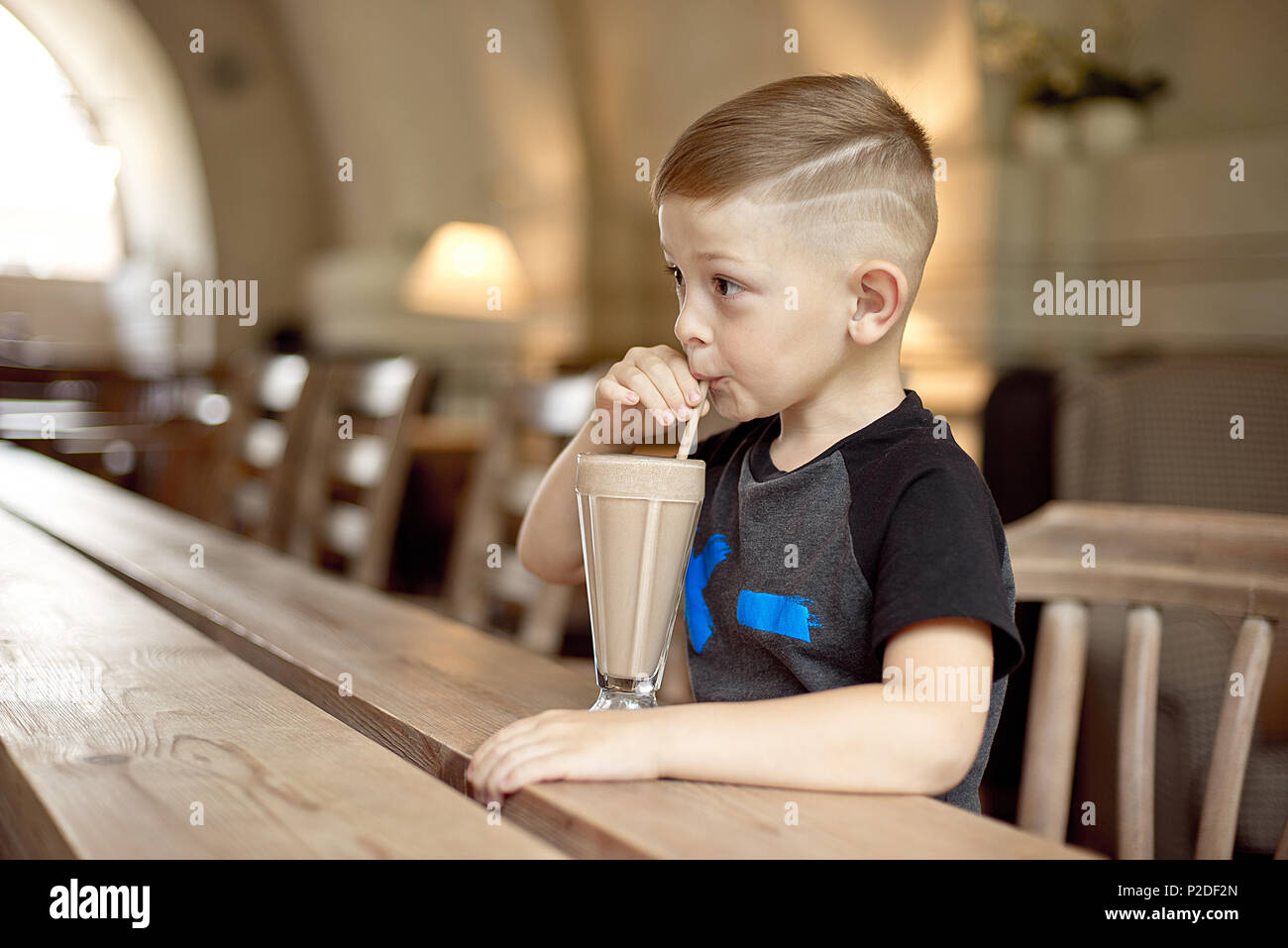 Boy in cafe drinking milkshake hi-res stock photography and images - Alamy