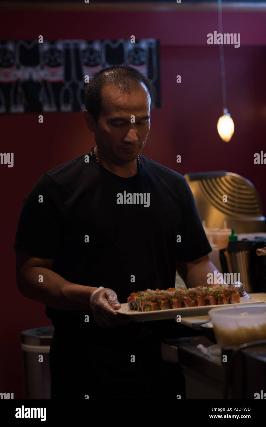 Chef carrying sushi in a tray Stock Photo - Alamy