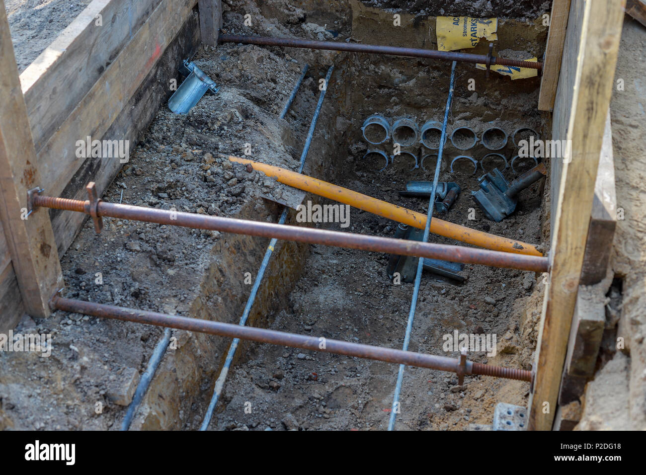 View into an excavation with exposed pipes of a power line Stock Photo ...
