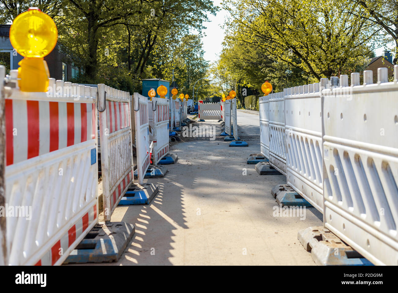 red and white barricades with warning lights on a street in a ...