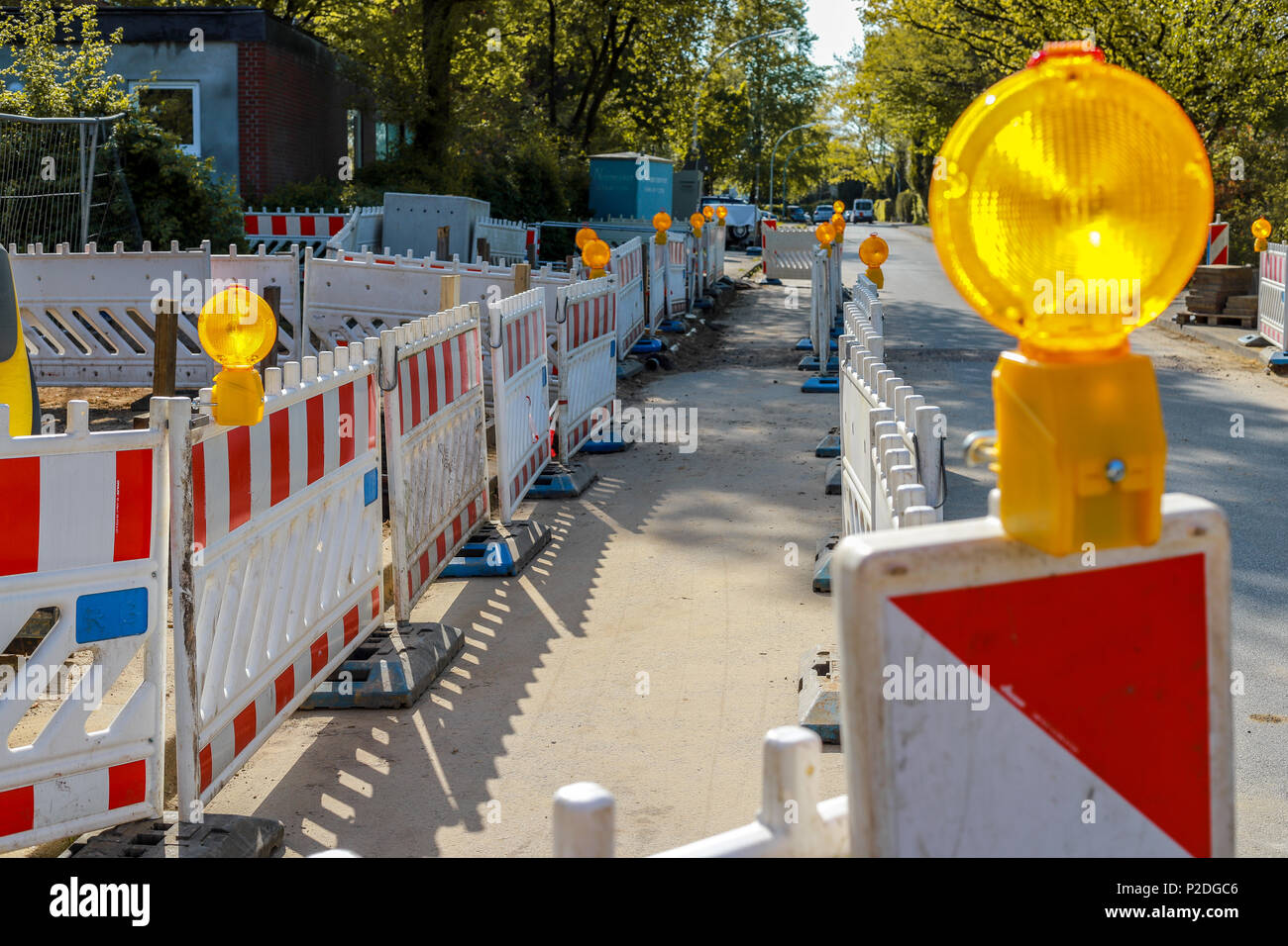 red and white barricades with warning lights on a street in a ...