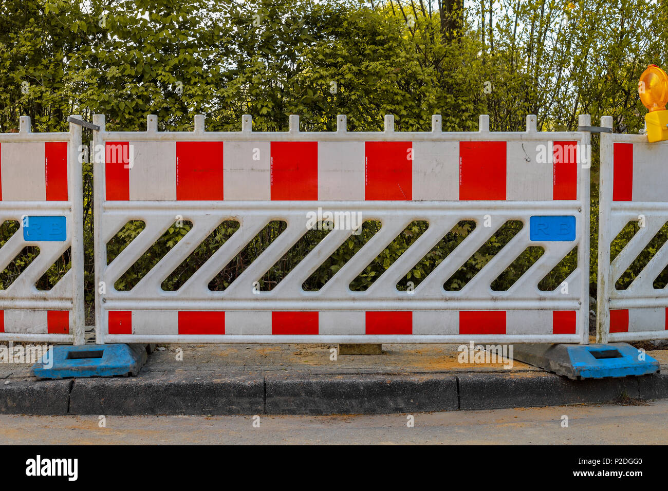 red and white barricades with warning light Stock Photo - Alamy