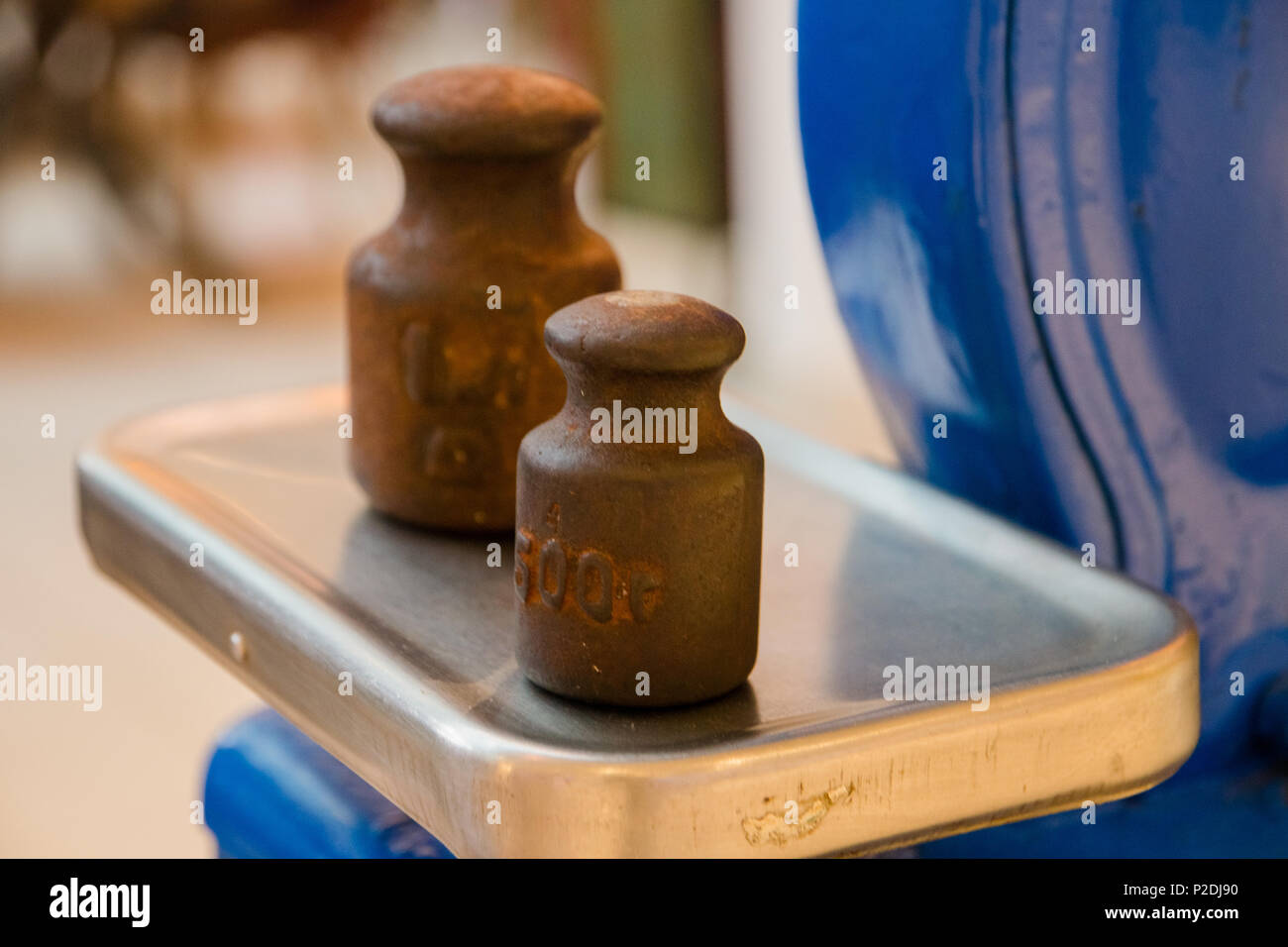 Old two weights on the scales Stock Photo - Alamy