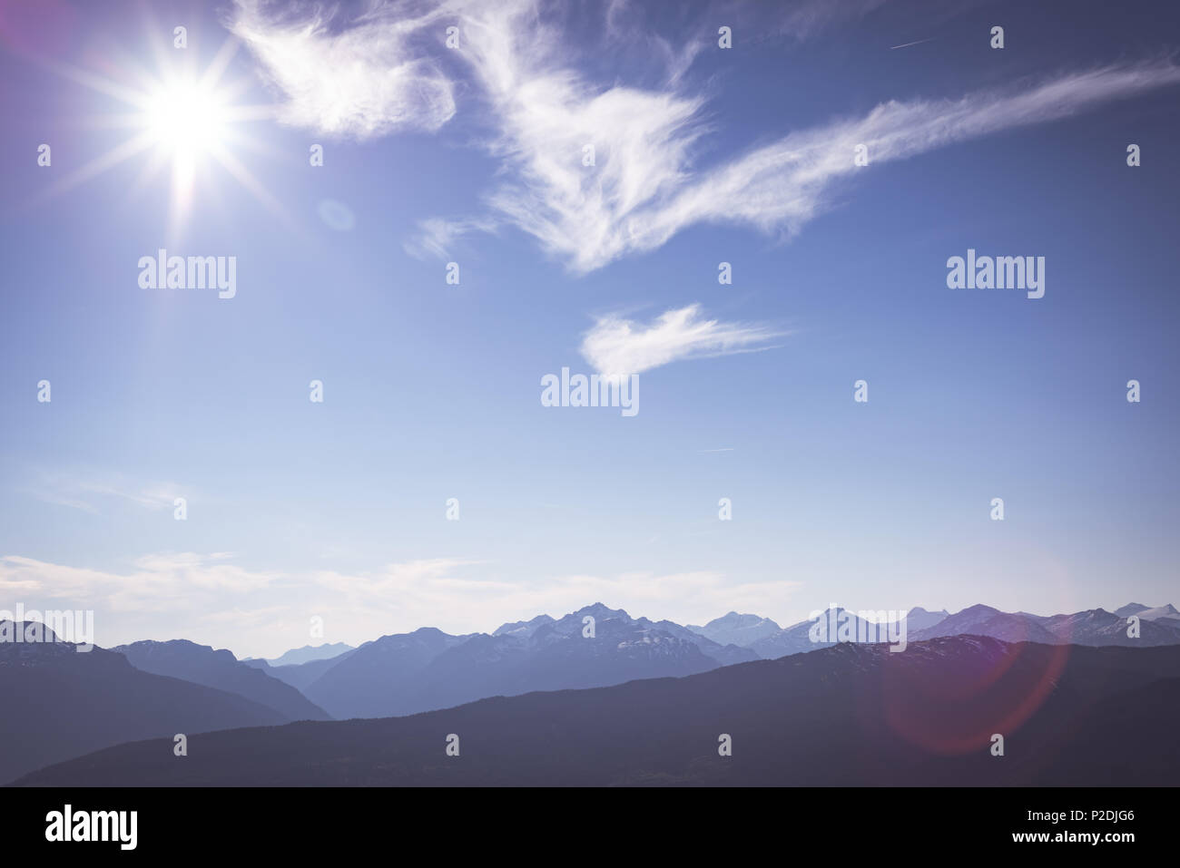Sun rising over rocky mountain range Stock Photo - Alamy