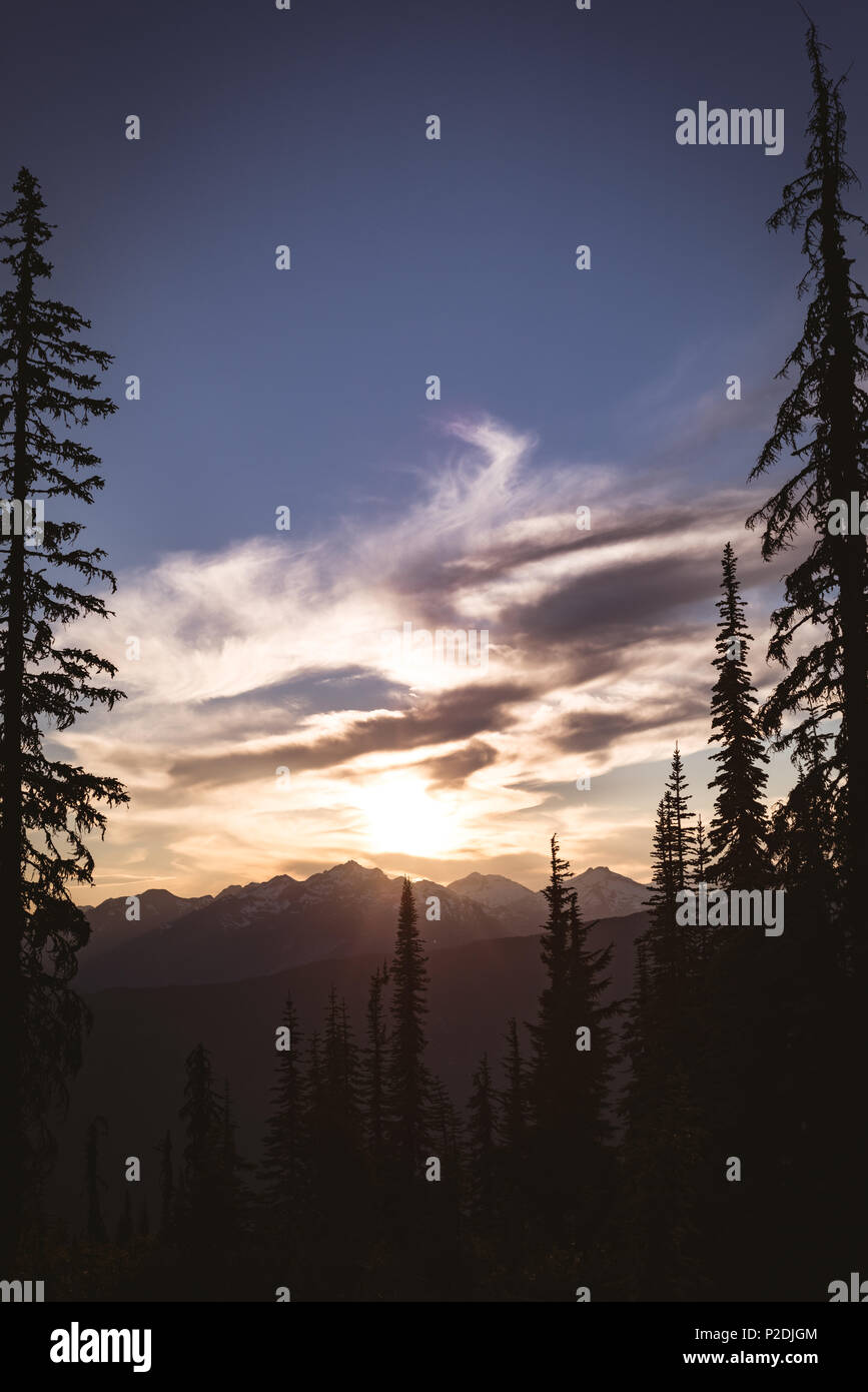 Sun rising over rocky mountain range Stock Photo - Alamy