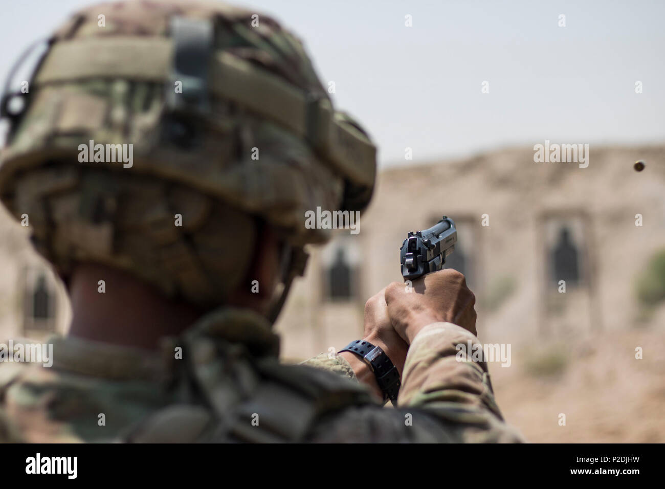 A U.S. Soldier fires his weapon during the M9 pistol marksmanship event ...