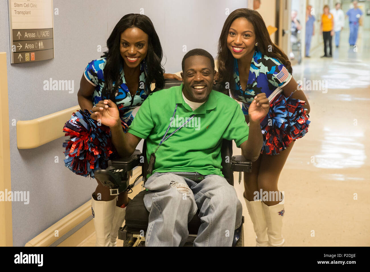 Daniel Brafford (Ret. Navy), poses for a photo with cheerleaders from ...