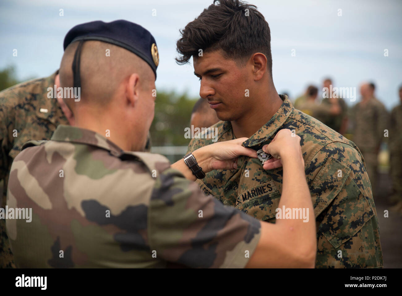 Cpl. Niko A. Lopez, a machine gunner, receives a pin signifying the ...