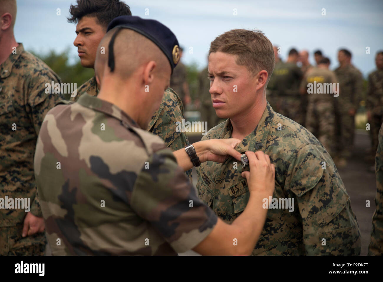 Sgt. Donald J. Conde III, a rifleman, receives a pin signifying the ...