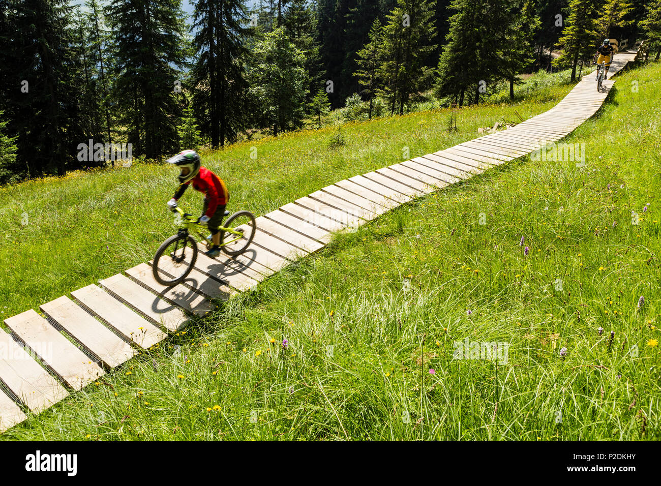 mountain biker on a wooden path in Bikepark Saalbach-Hinterglemm ...
