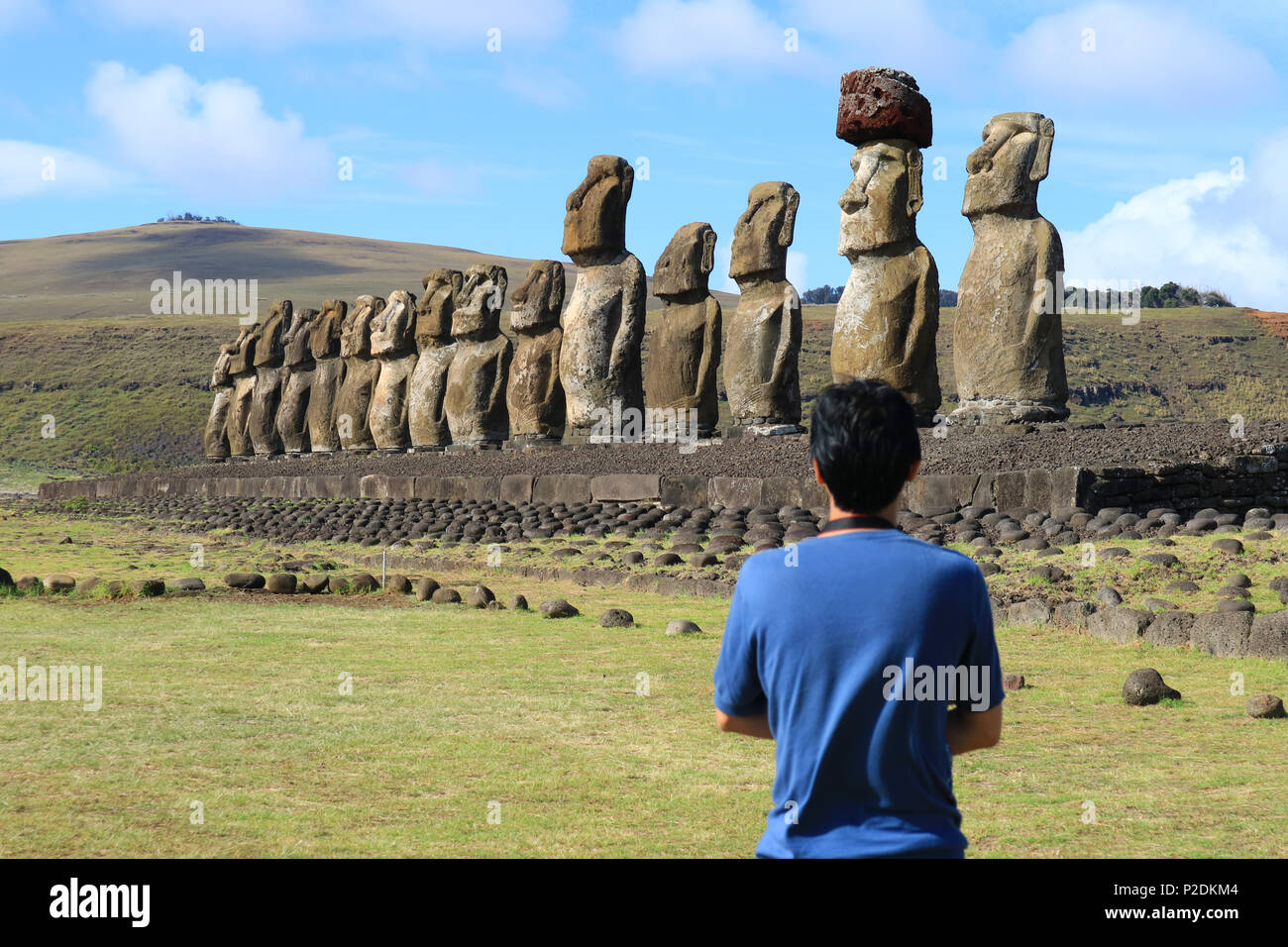 One man admiring the huge Moai statues of Ahu Tongariki, Easter Island ...