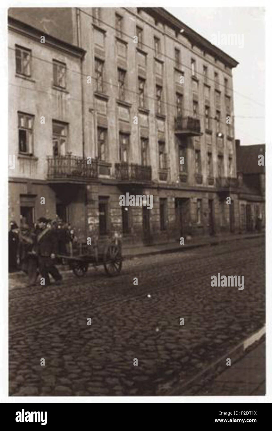 . English: Ghetto Litzmannstadt: Men haul a cart down the street in the ...