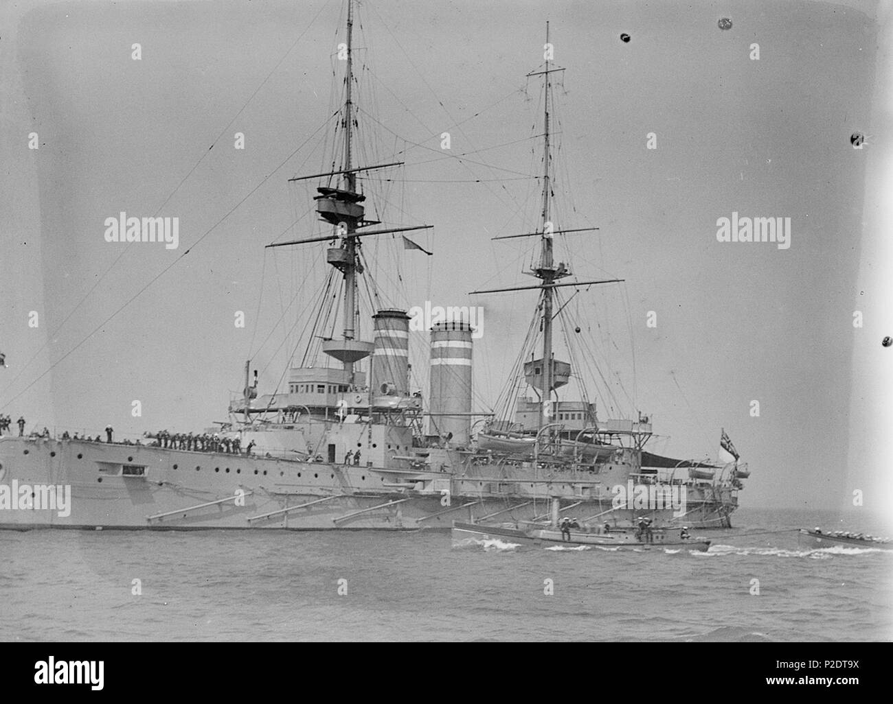 . Photograph showing port bow view of British battleship HMS Queen with ...