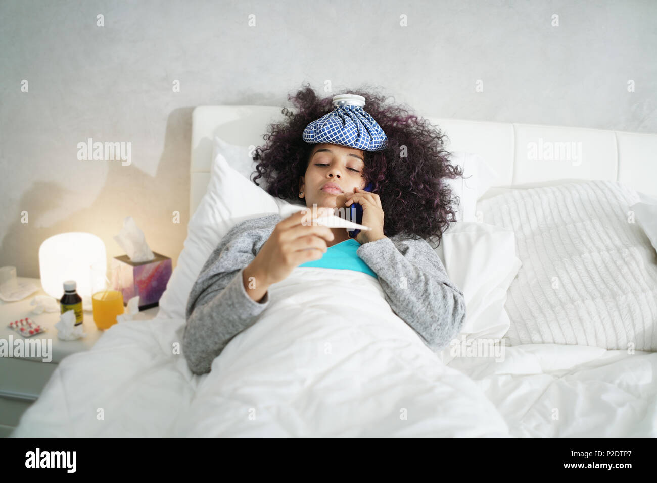 Woman With Fever Using Thermometer And Calling Doctor By Phone Stock ...