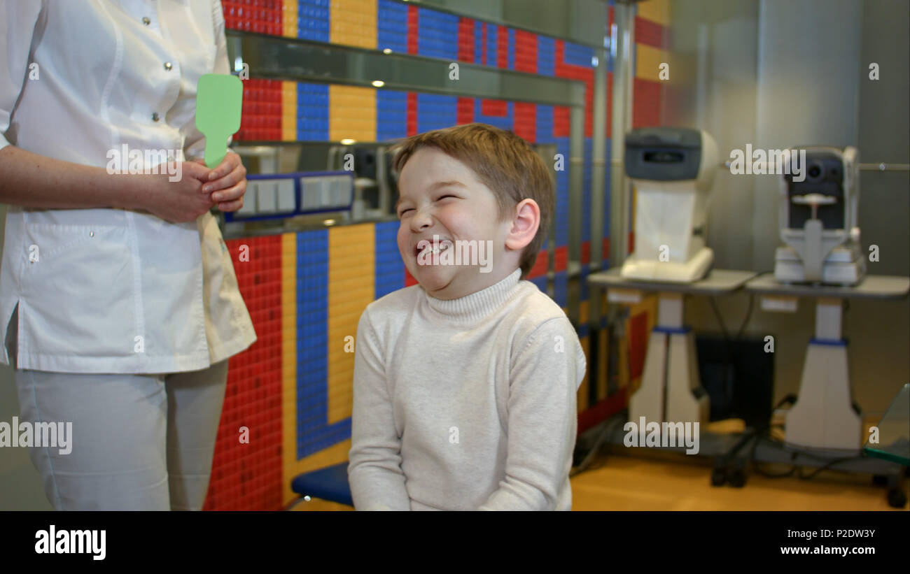 Happy child reviewing eyesight Stock Photo - Alamy
