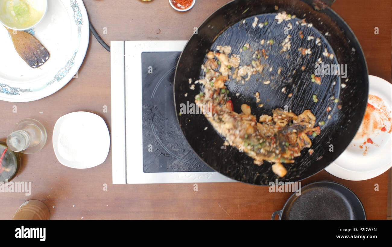Mixing paella and seafood in a pan, cooking Stock Photo - Alamy
