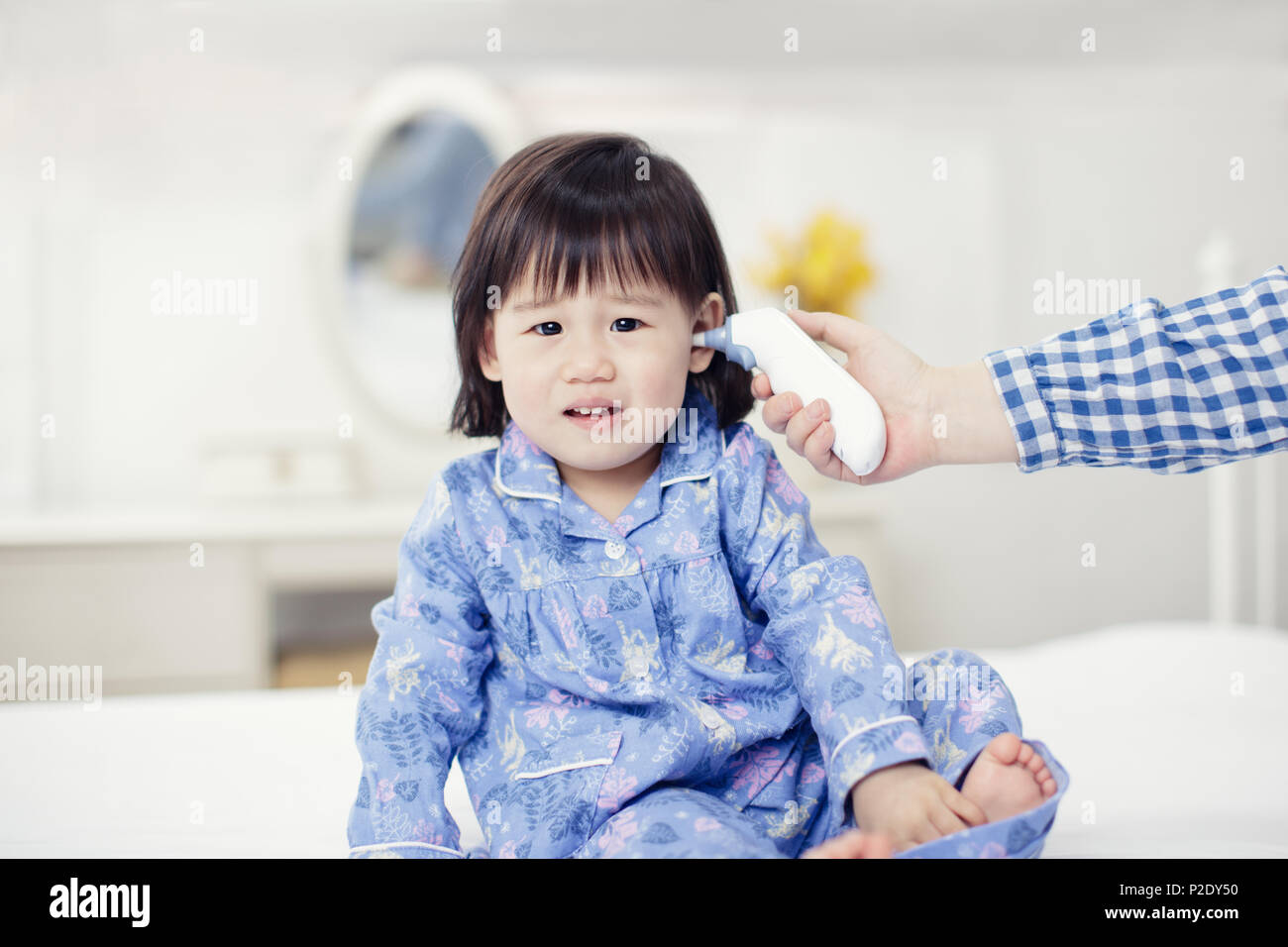 taking baby girl temperature using electric probe Stock Photo - Alamy