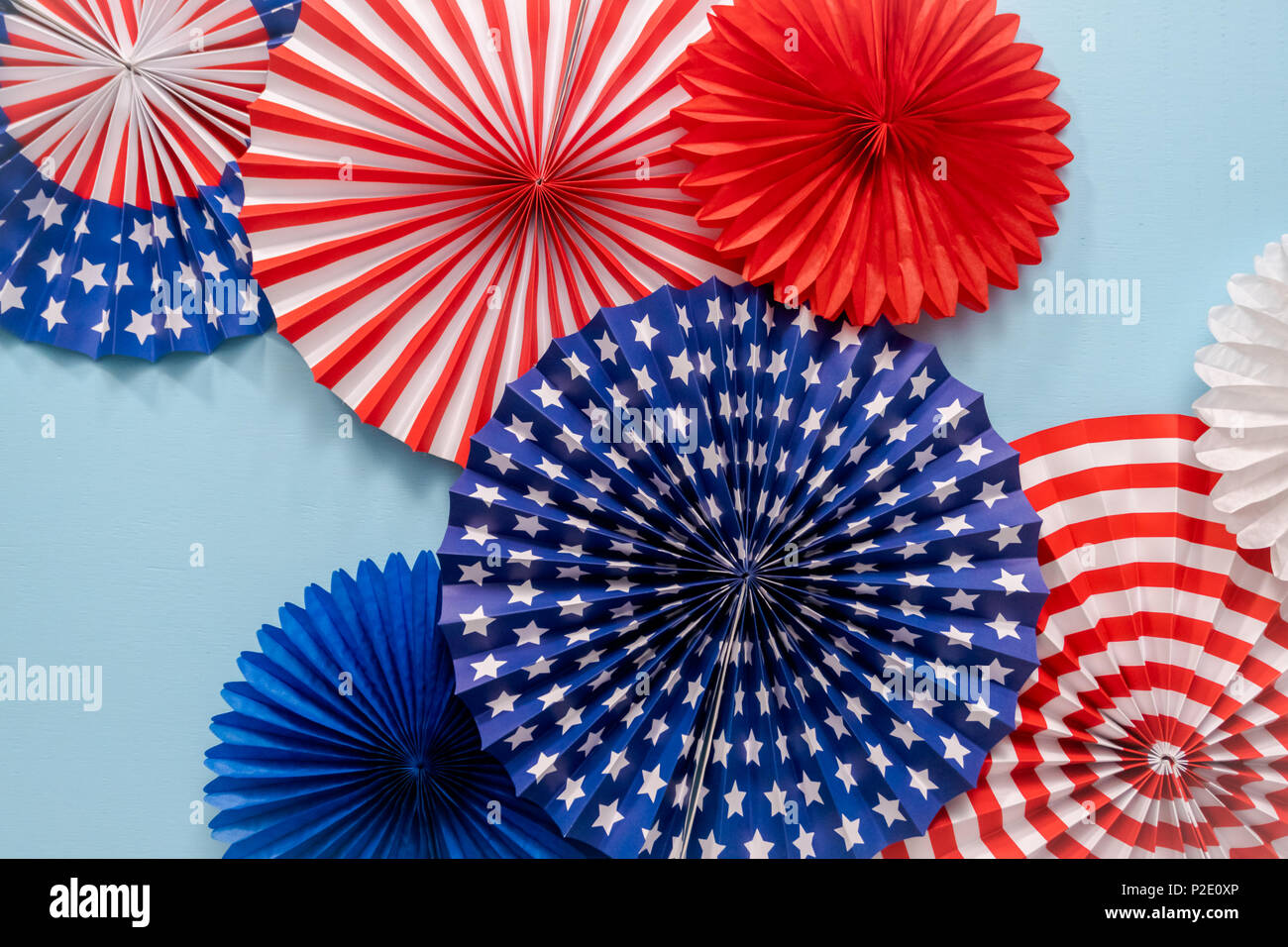 July 4th theme paper fans on blue background Stock Photo - Alamy