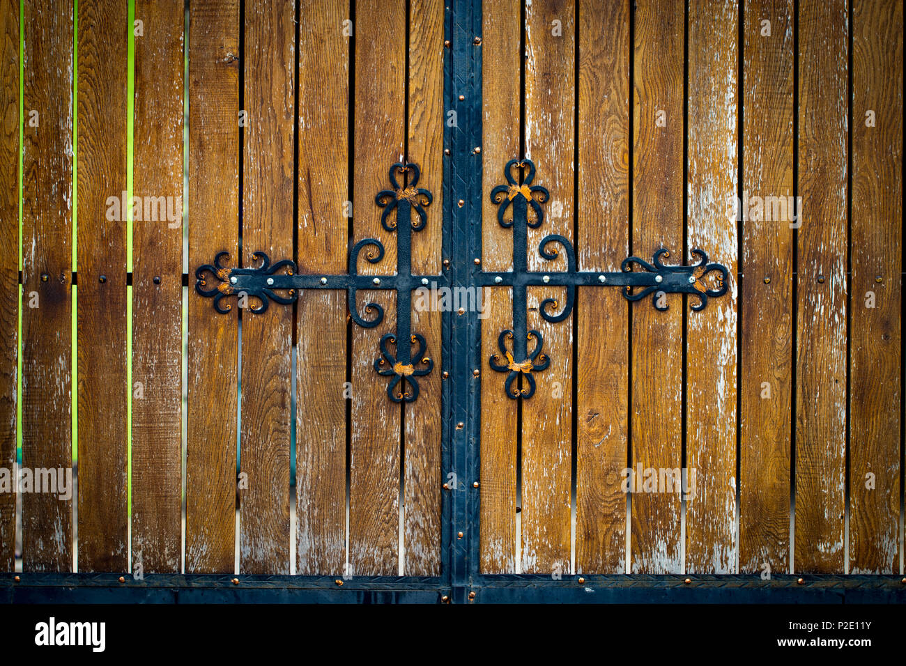 wooden gate with wrought iron elements close up Stock Photo - Alamy