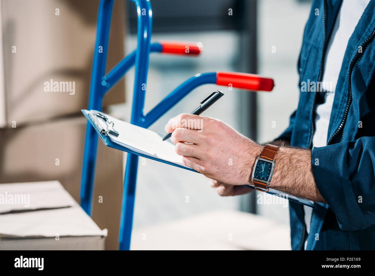 Close-up view of delivery man filling cargo declaration Stock Photo - Alamy