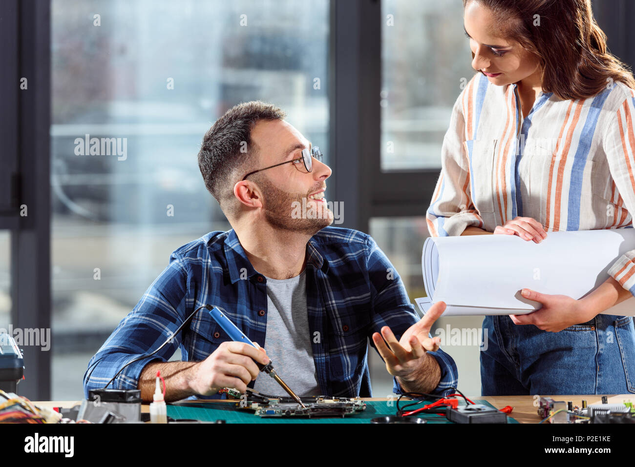 Woman and man engineers working and discussing project Stock Photo - Alamy
