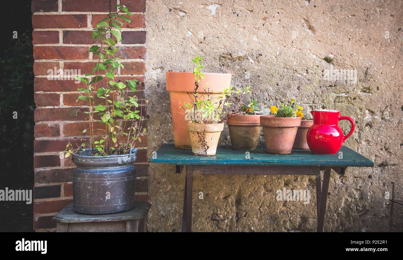 Pots and vases on a table in rural france Stock Photo - Alamy